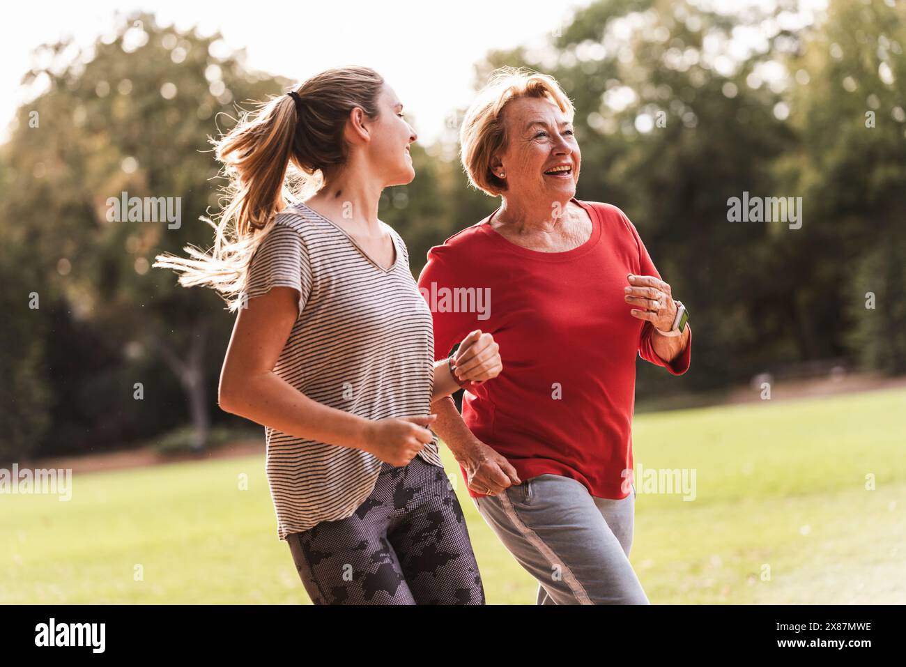 Happy grandmother and granddaughter jogging in park Stock Photo - Alamy