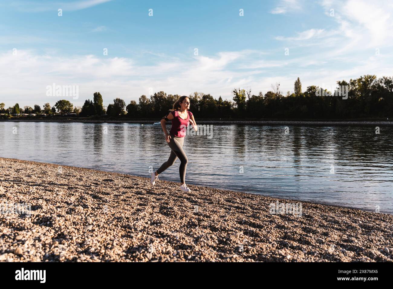 Young woman jogging near river hi-res stock photography and images - Alamy