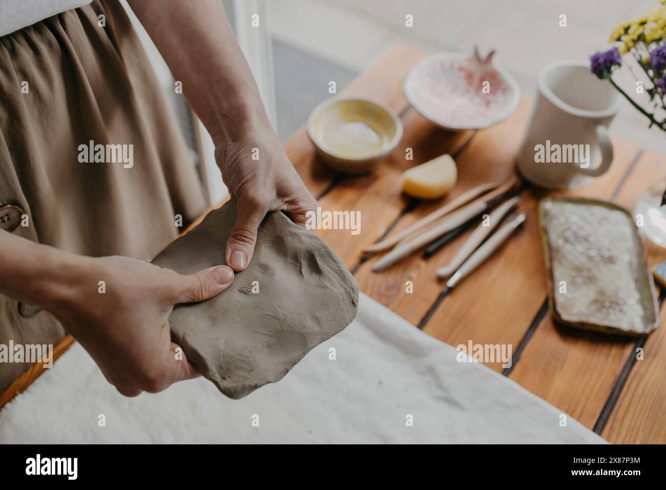 Craftsperson molding clay with hands at home Stock Photo - Alamy