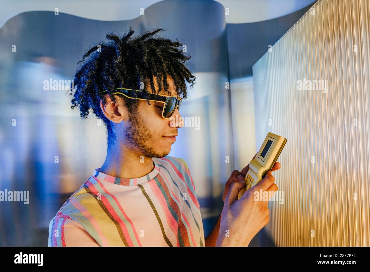 Young man with dreads playing video game Stock Photo - Alamy