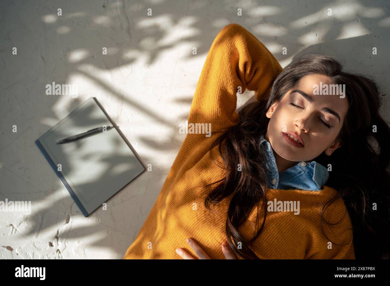 Young woman with closed eyes lying on the floor hi-res stock photography and images - Alamy