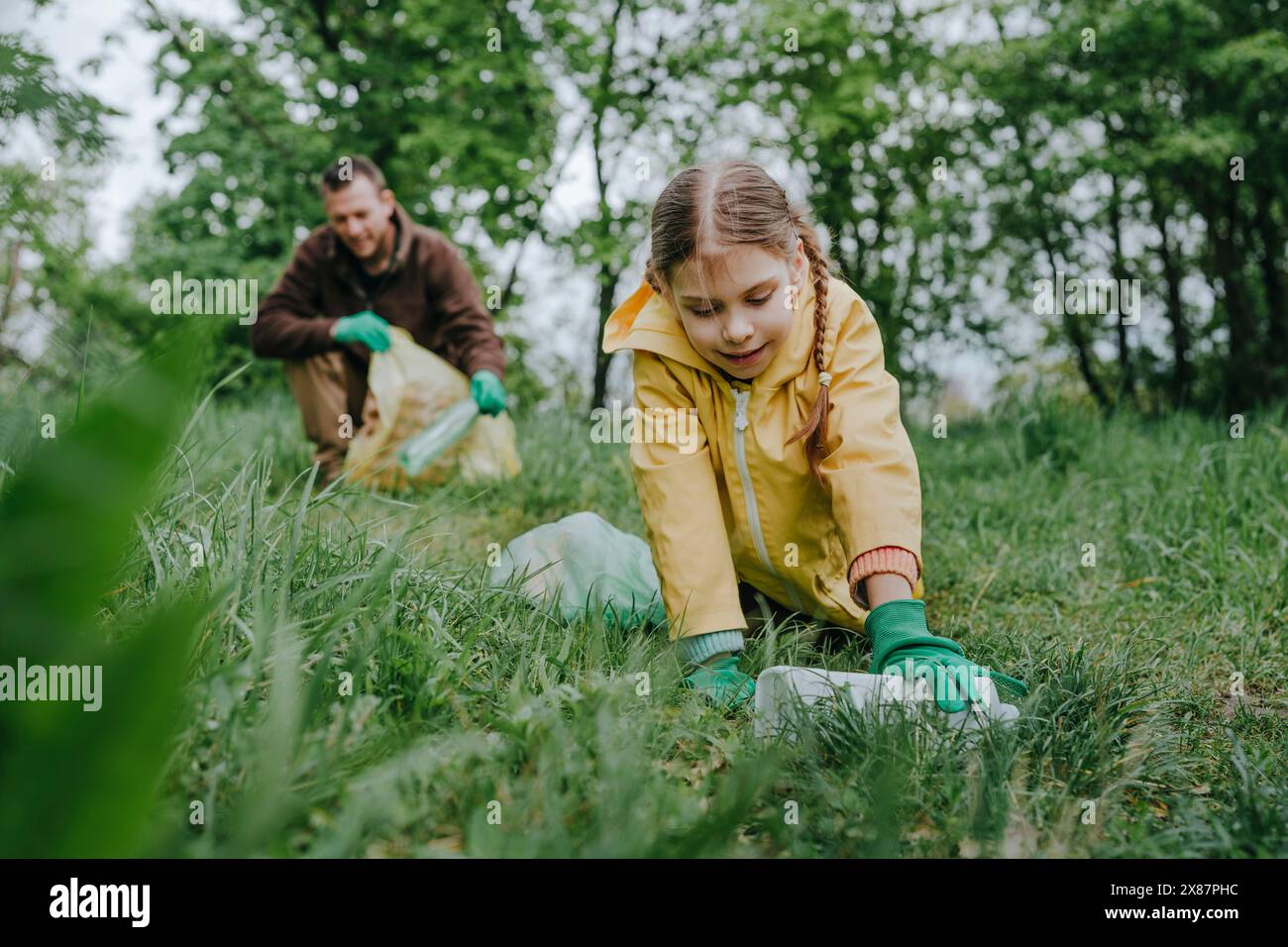 Daughter and father collecting plastic bottles cleaning forest Stock ...