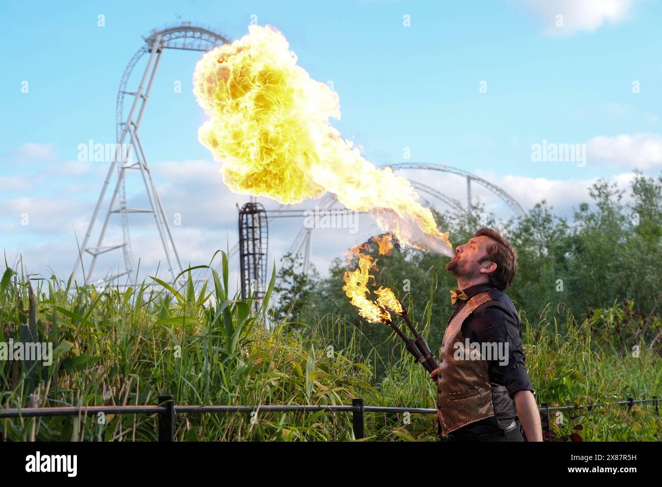EDITORIAL USE ONLY A fire eater performs at Thorpe Park's VIP launch ...