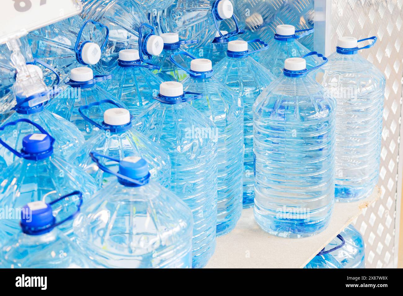 A variety of water bottles are neatly arranged on a shelf, showcasing ...