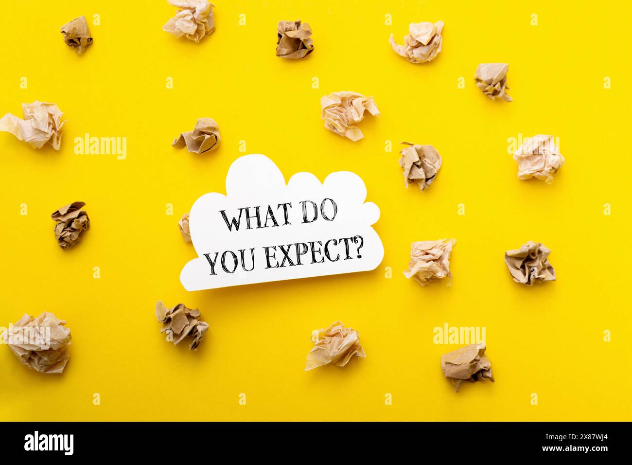 A yellow background with a white sign that says What do you expect ...