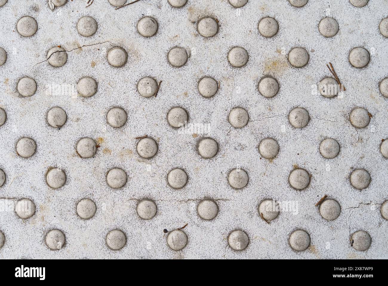 A concrete floor with an abundance of holes scattered throughout ...