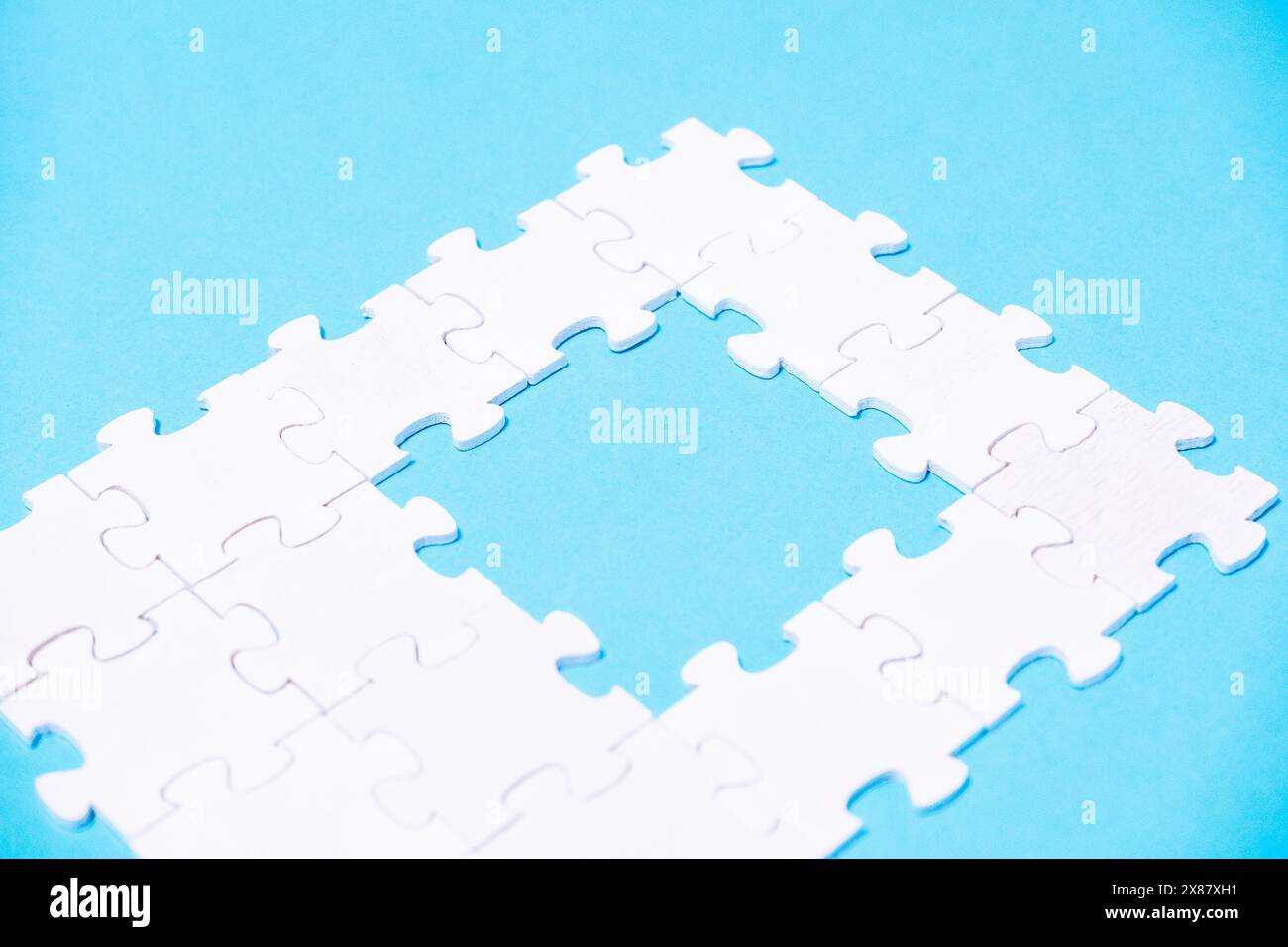 A puzzle piece is missing from a puzzle, leaving a gap in the middle ...