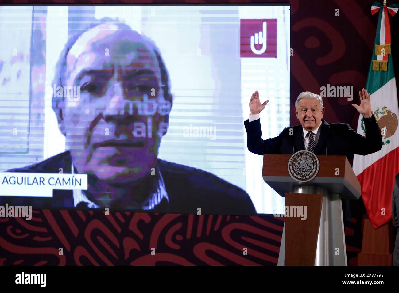 Mexican President Andres Manuel Lopez Obrador shows a slide by the ...