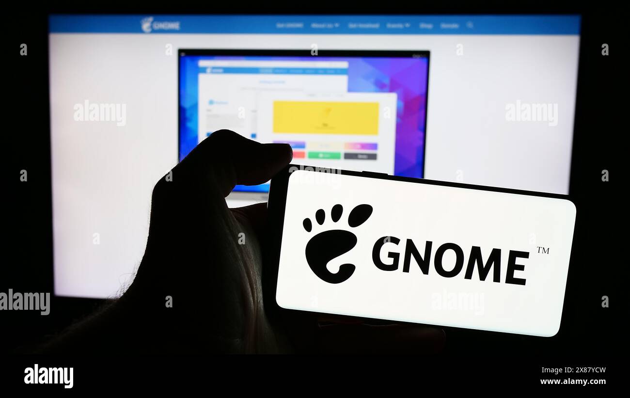 Person Holding Mobile Phone With Logo Of Open Source Gnu Network Object Model Environment Gnome