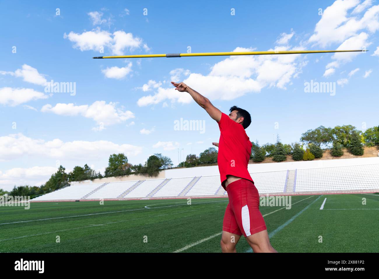 An athletic man throws the javelin in the stadium Stock Photo - Alamy
