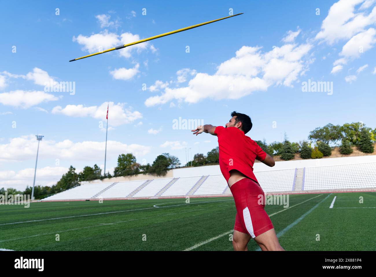 An athletic man throws the javelin in the stadium Stock Photo - Alamy