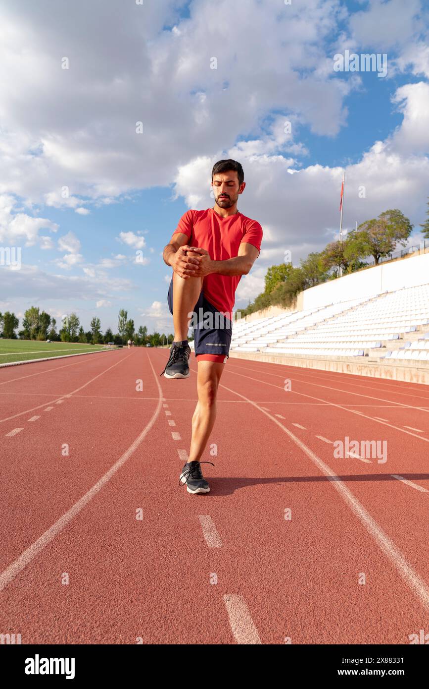 Athlete warming up by stretching before exercise. man doing stretching ...
