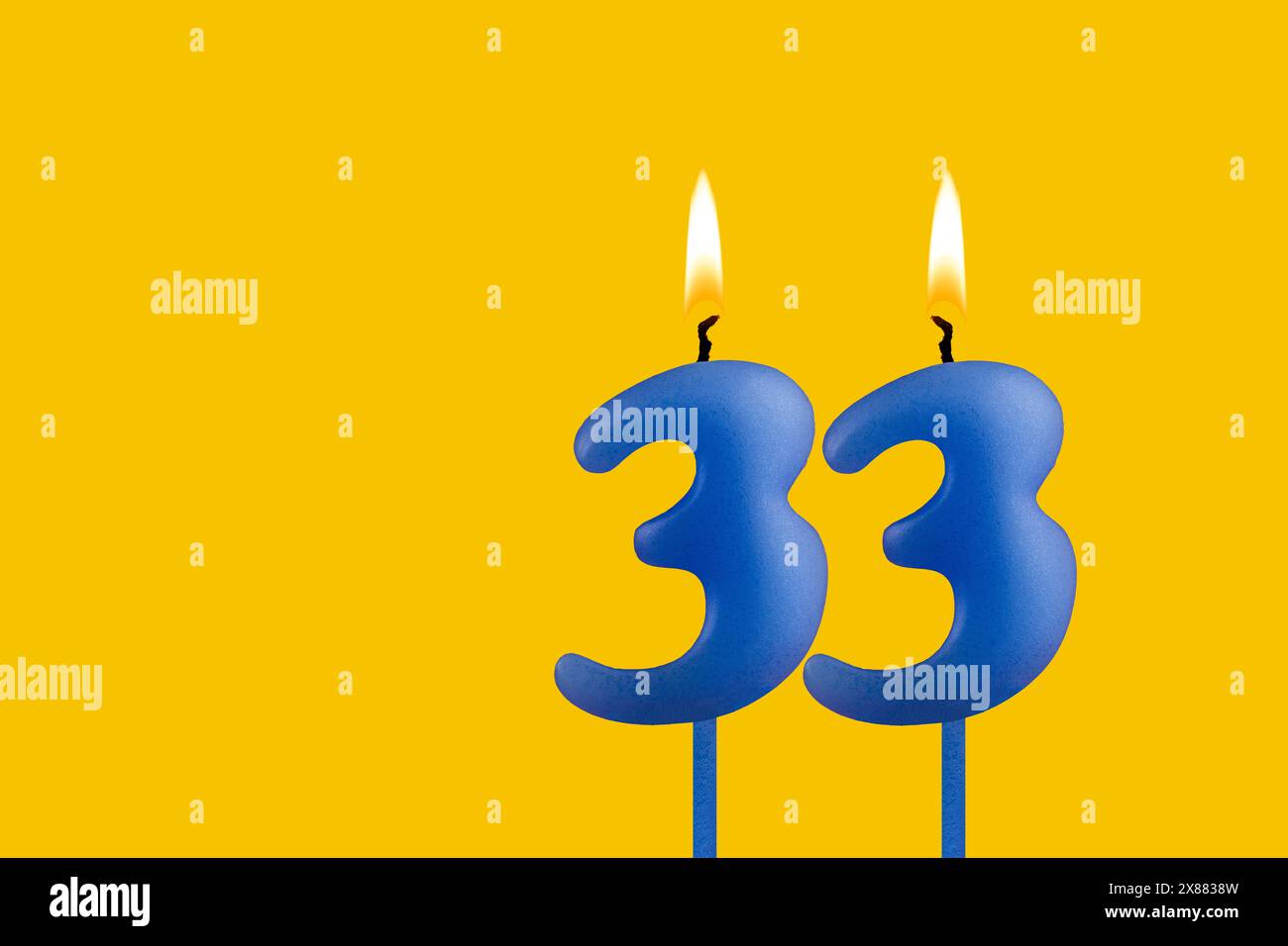 Blue birthday candle on yellow background - Number 33 Stock Photo - Alamy