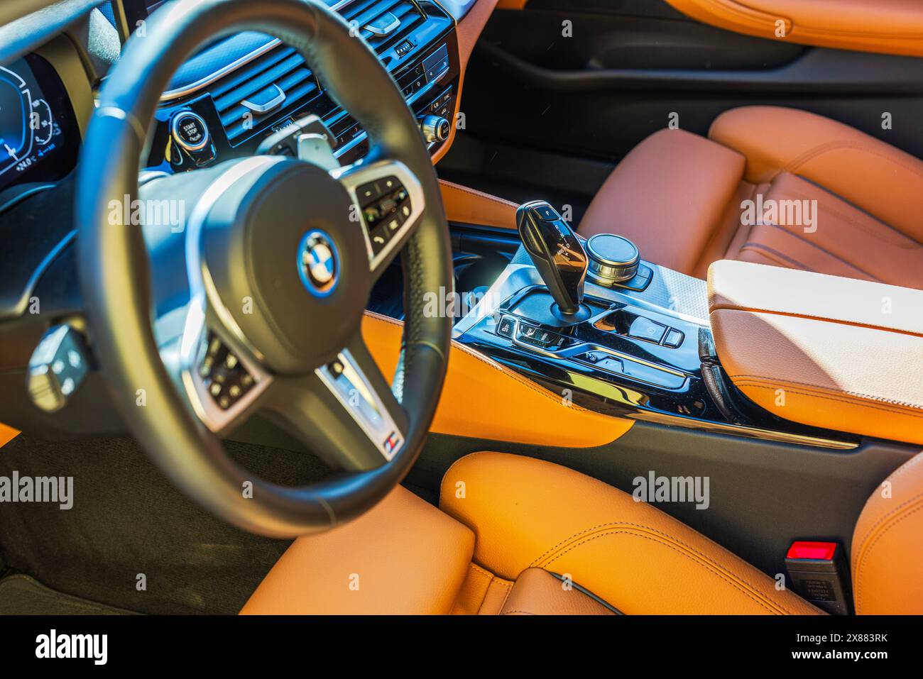 Close-up view of the interior of the BMW i4 electric car with orange ...