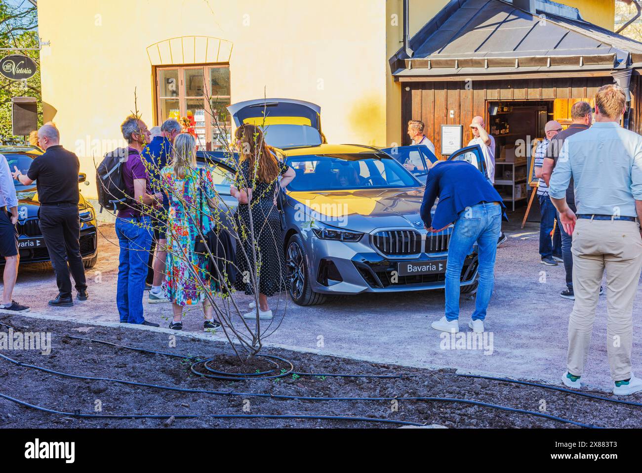 Visitors marvel at the unveiling of the latest BMW i5-M electric car at ...