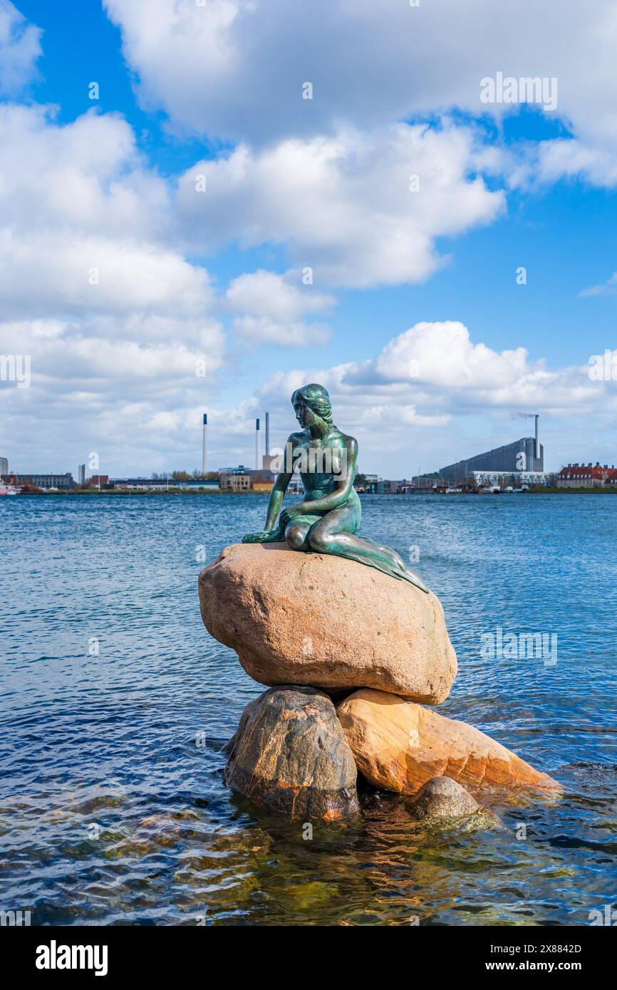 COPENHAGEN, DENMARK - APRIL 14, 2024: Bronze statue of the Little Mermaid sitting on a rock at ...