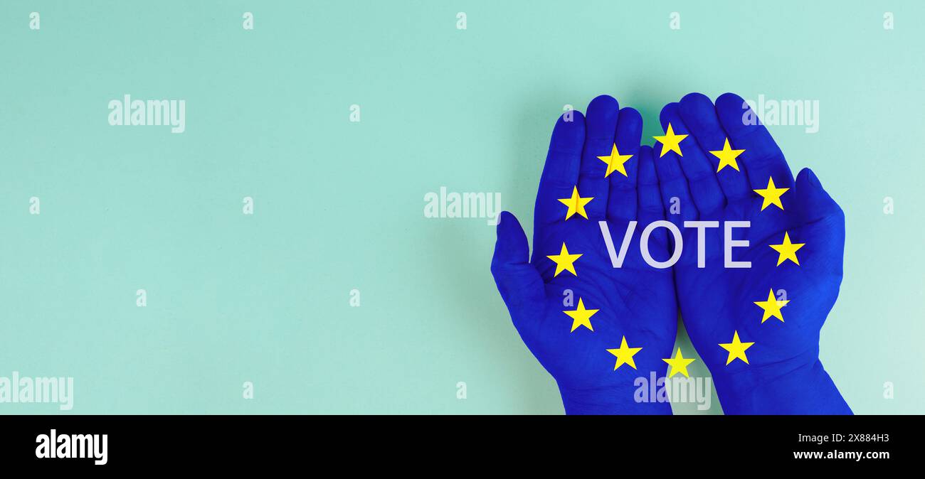 EU election, hand with european union flag, blue and yellow stars ...