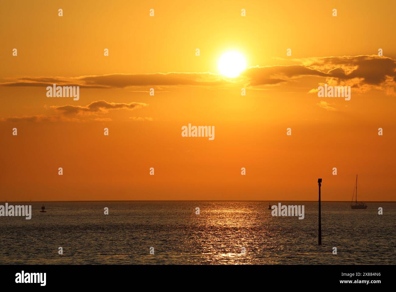 Golden sunset seen from River Wyre shore footpath at Knott End-on-Sea ...