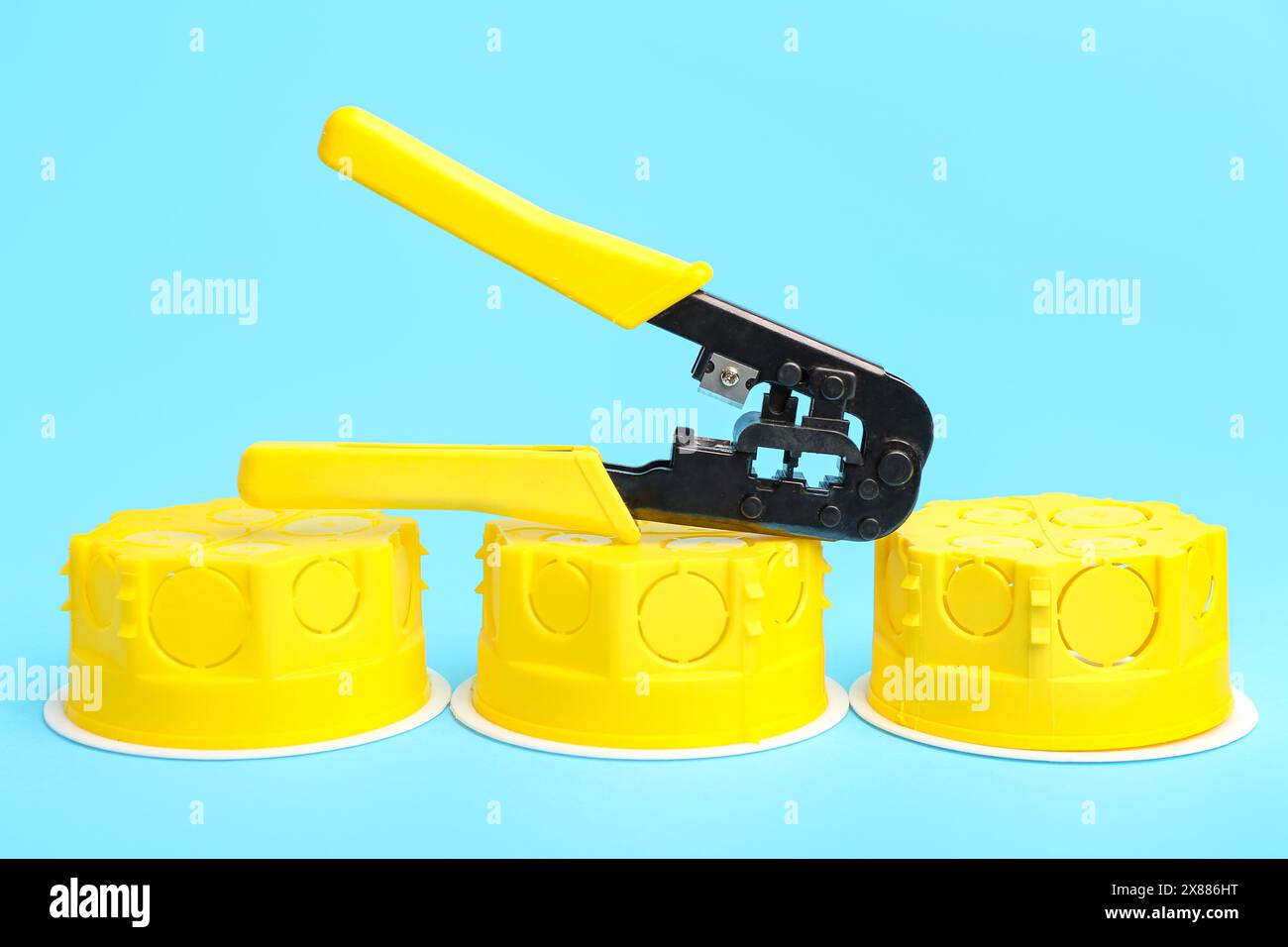 Set of mounting boxes and wire stripper on color background Stock Photo ...