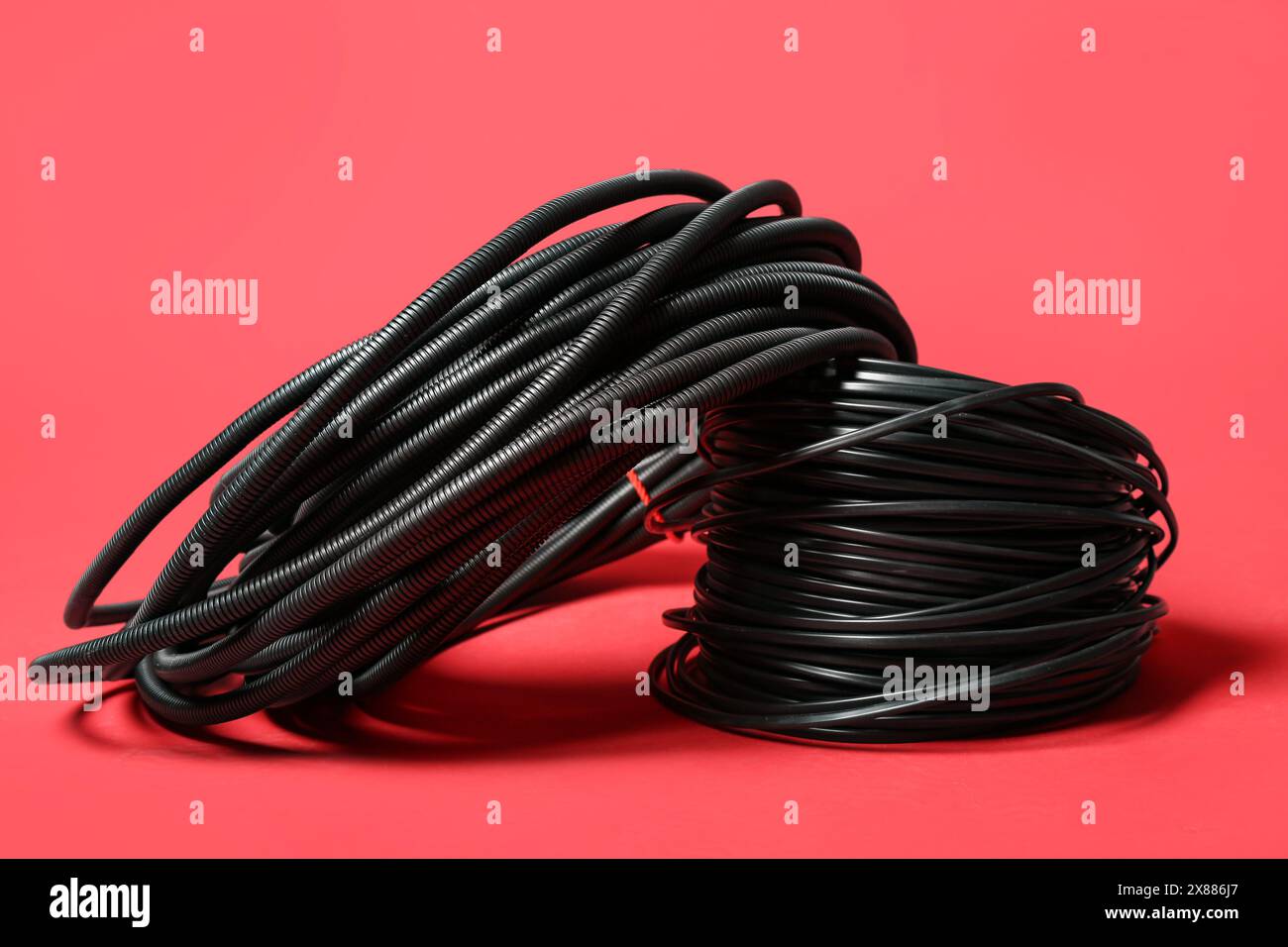 Rolled cables on red background, closeup Stock Photo - Alamy