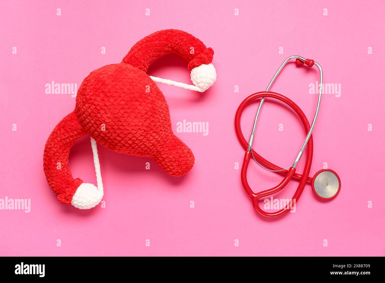 Knitted uterus and stethoscope on pink background Stock Photo - Alamy