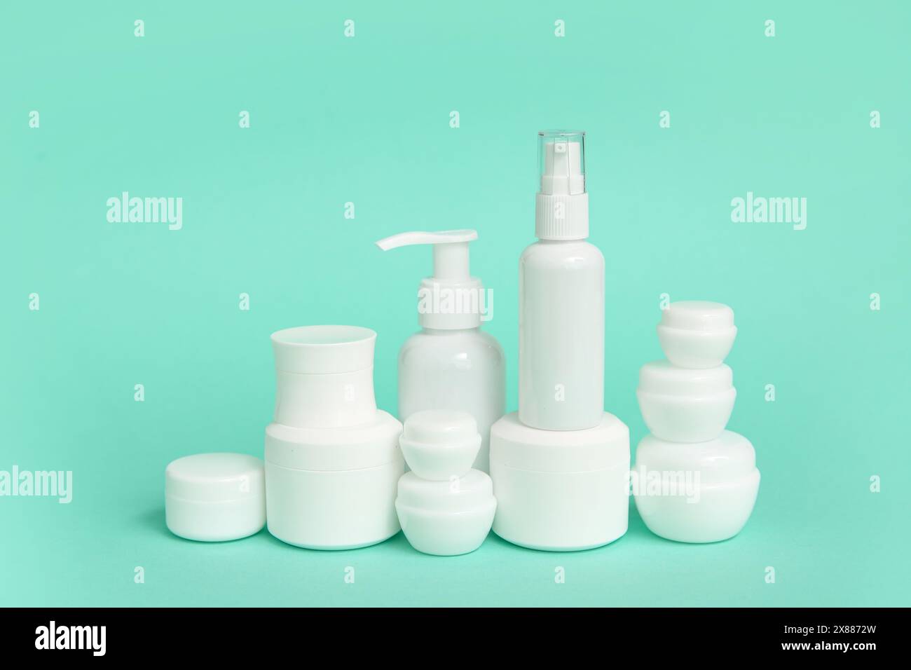 Different cosmetic products on green background Stock Photo - Alamy