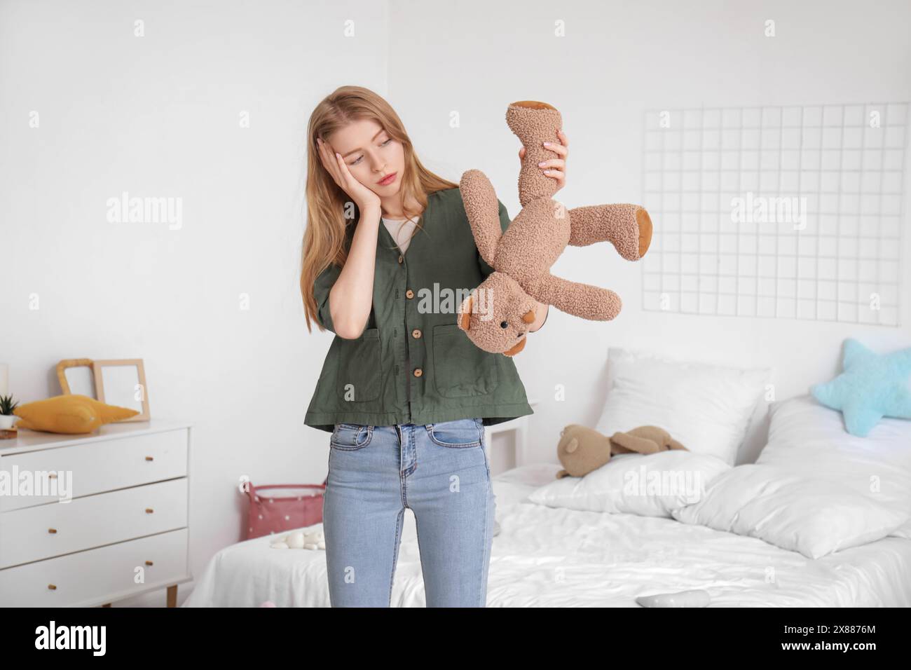 Portrait of tired young mother with teddy bear at home Stock Photo - Alamy