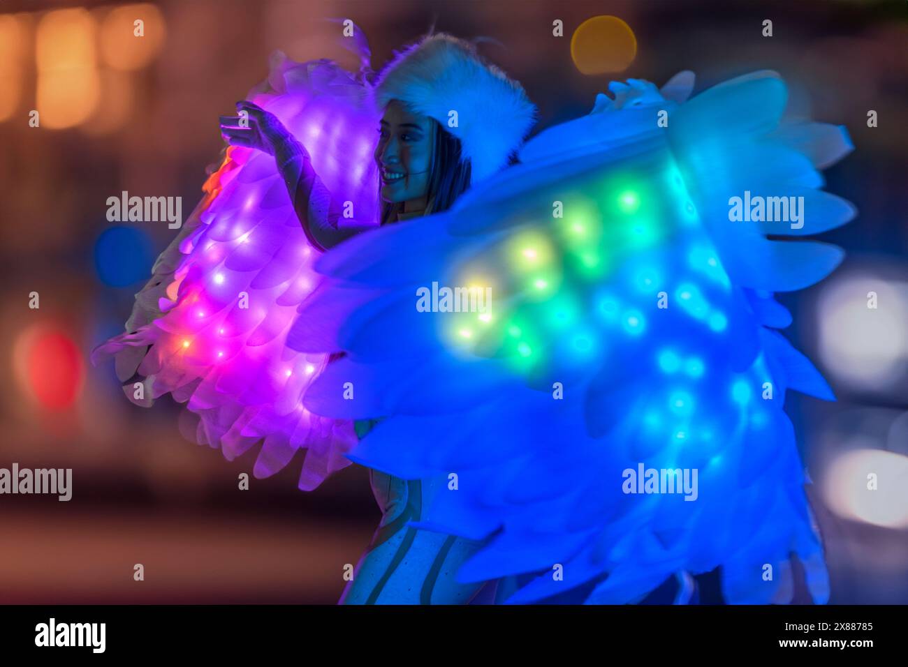 Young Asian girl wearing angel wings at the Chinook Blast Winter ...