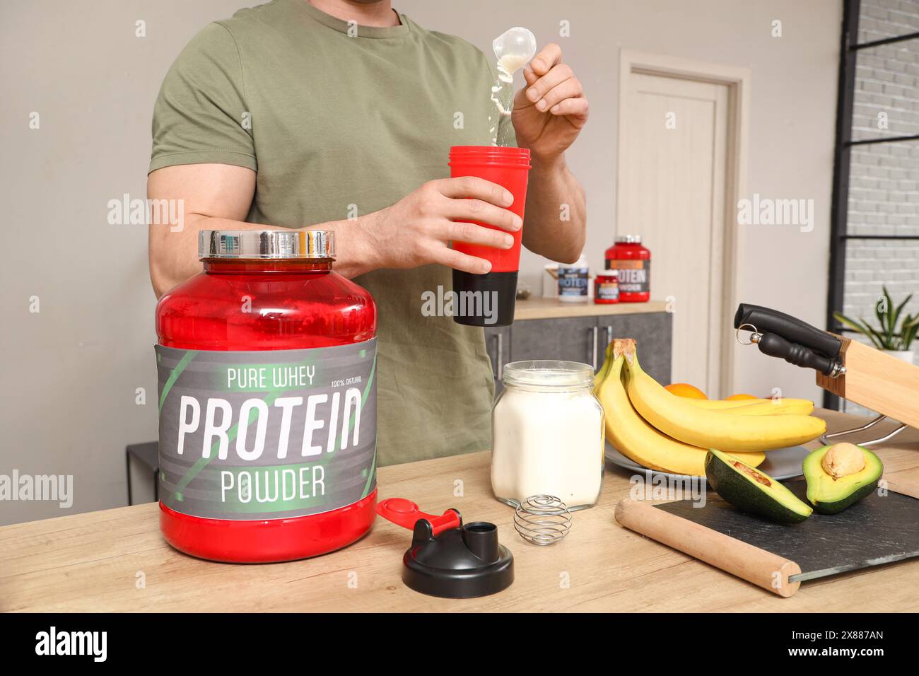 Muscular man preparing protein cocktail hi-res stock photography and ...