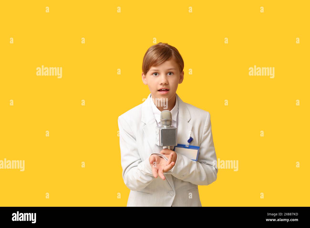 Portrait of teenage journalist with microphone taking interview on ...