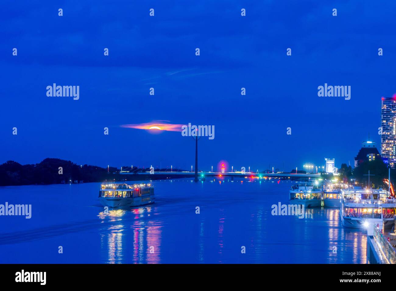 full moon above river Donau Danube, cruise ship, bridge ...