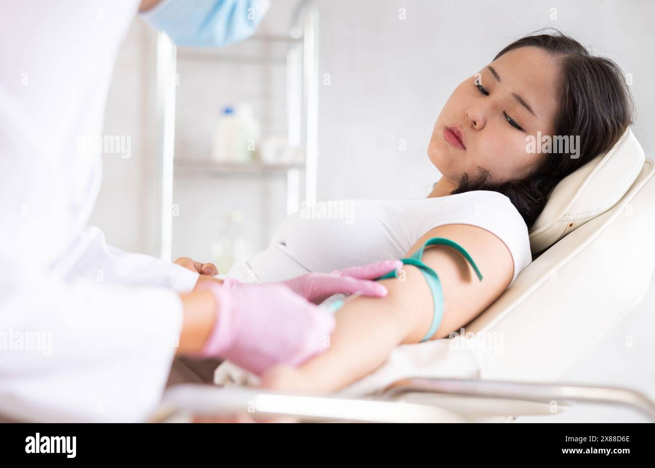 Middle-aged doctor giving injection into vein Stock Photo - Alamy