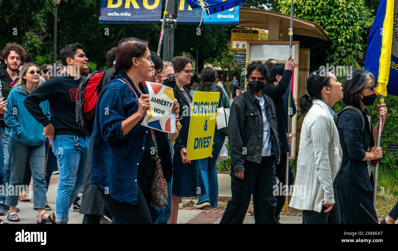 Los Angeles, USA. 23rd May, 2024. Protesters hold signs reading ...