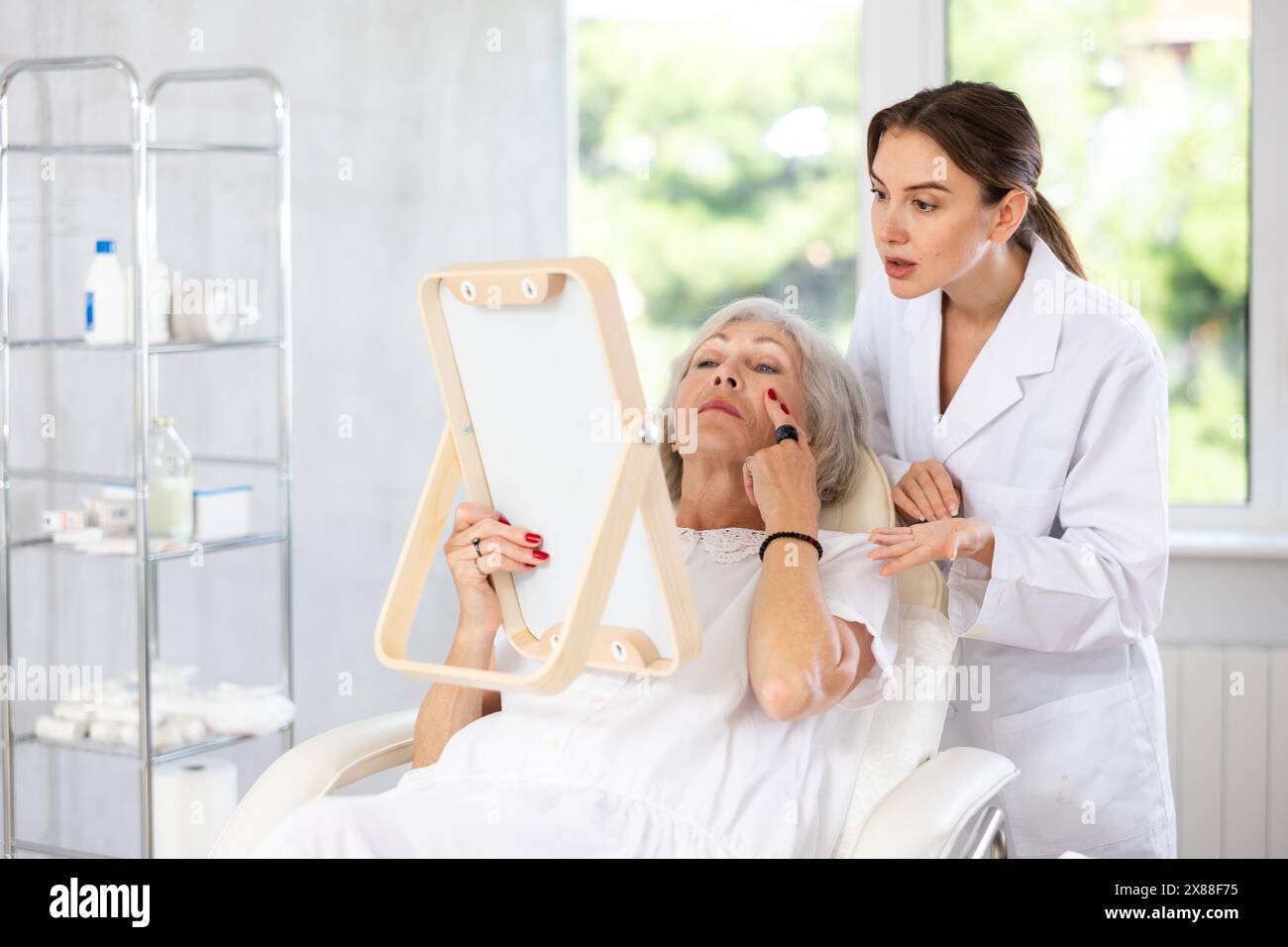 Mature patient with mirror Stock Photo - Alamy
