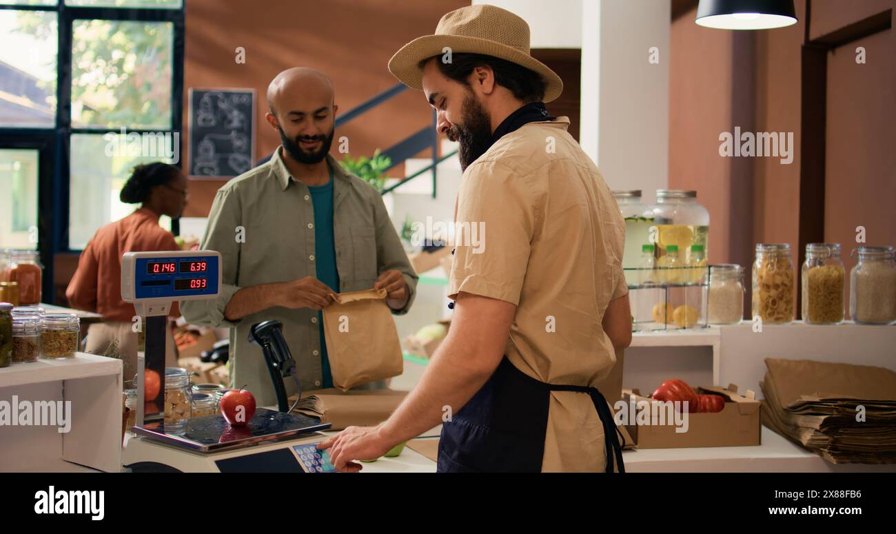 Local vendor weighting goods at checkout cash register, using ...