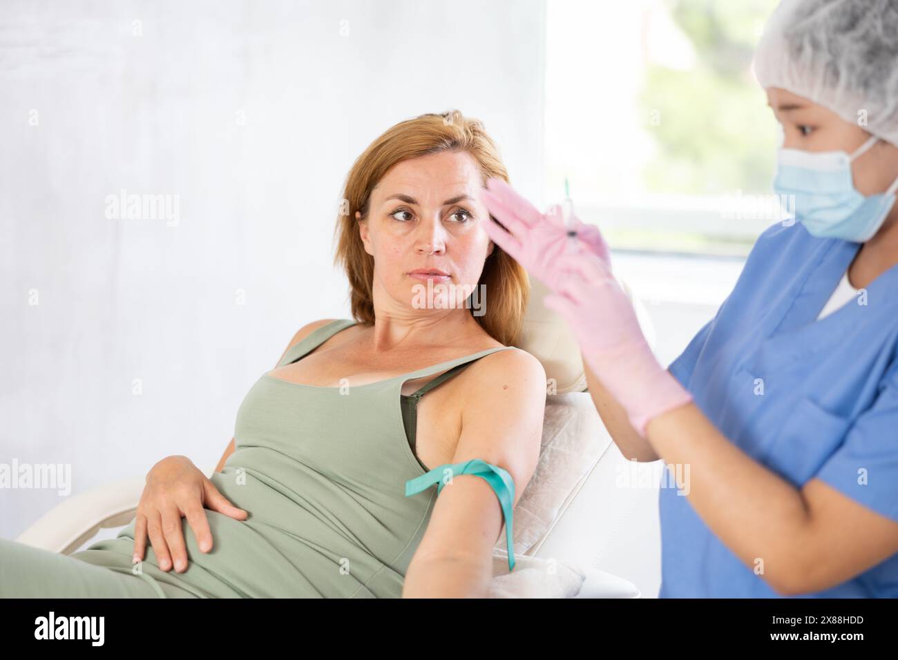 young doctor giving injection into vein Stock Photo - Alamy