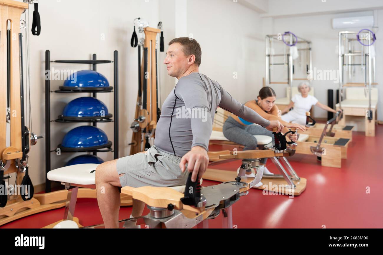 Man performs Pilates exercises for weight loss and toning muscles of ...