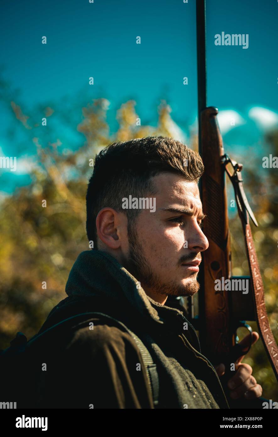 Hunter with shotgun gun on hunt. Hunter in the fall hunting season. Man ...