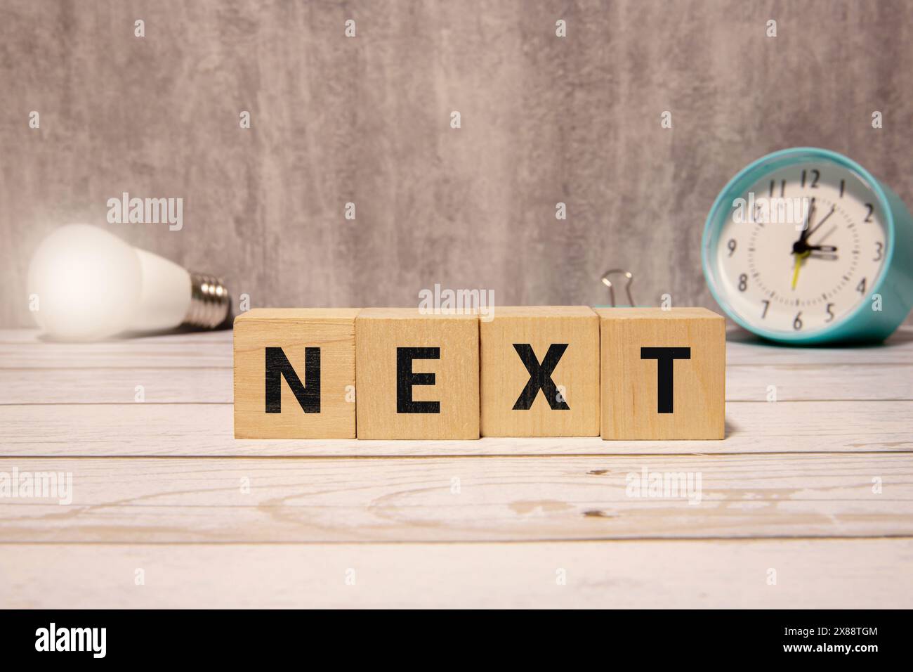 The word NEXT handwritten on white background. Next level or step in business or education ...