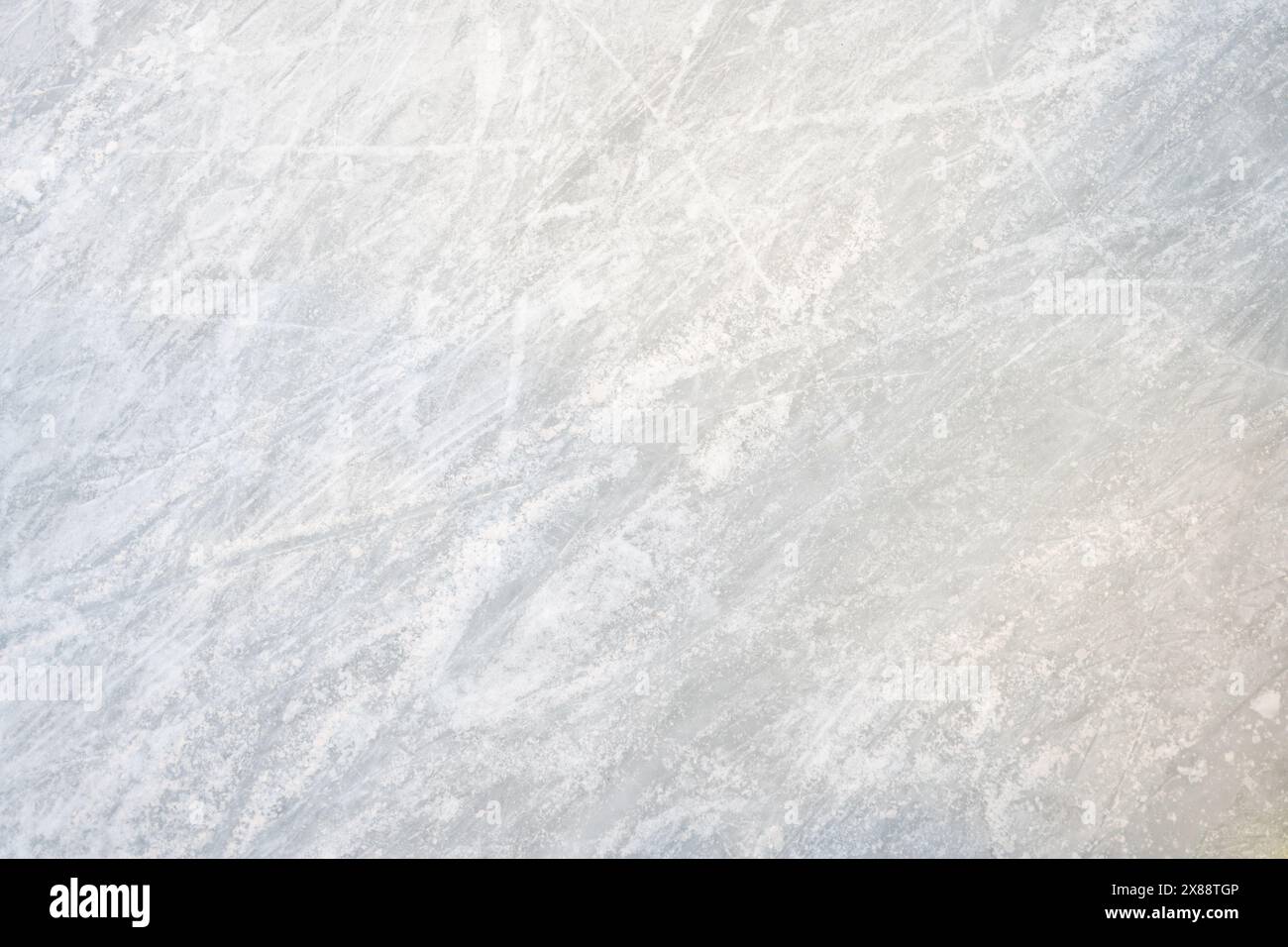 Icy background on rink reveals visible traces of skating, capturing the ...