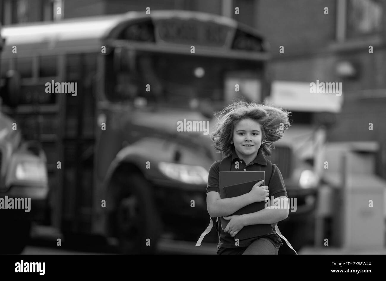 Schoolkid getting on the school bus. American School. Back to school ...