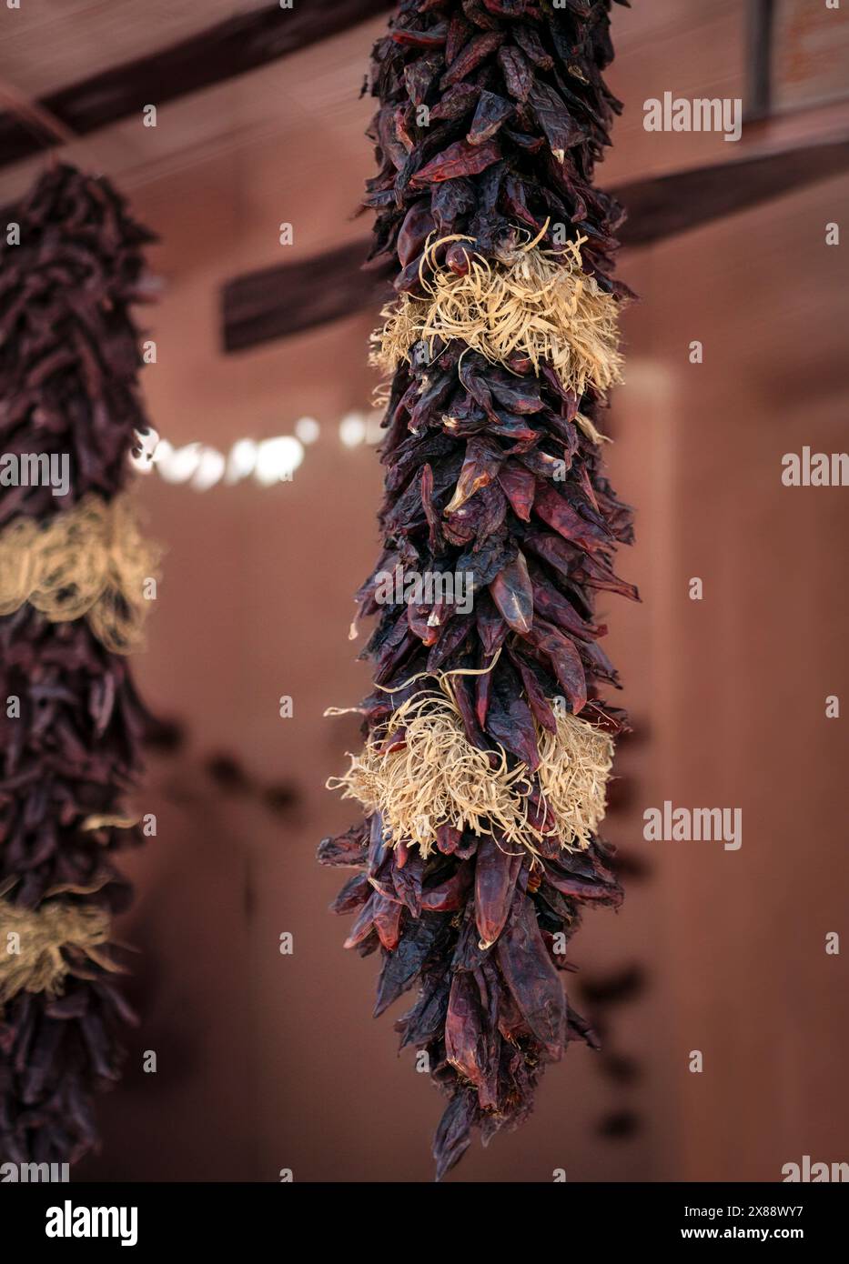 A cultural icon of New Mexico, red chili ristras hangs on the front ...