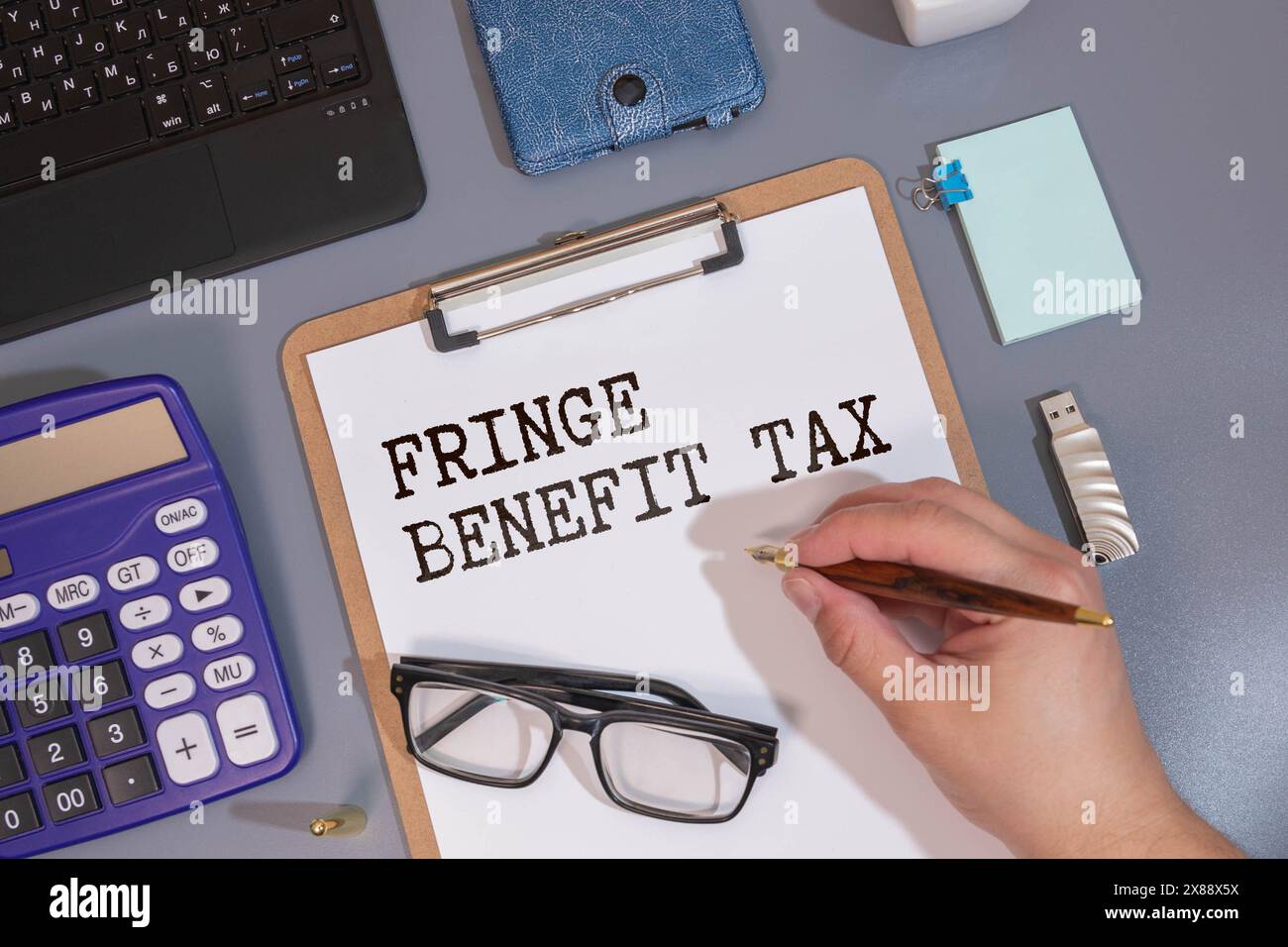 Fringe Benefit Tax write on a book isolated on Wooden Table Stock Photo ...