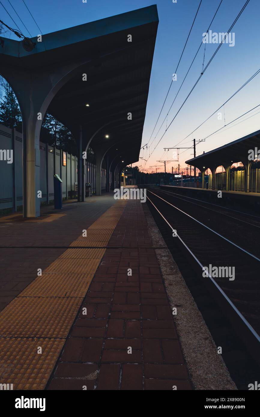 A beautiful railway station in the rays of a colorful sunset. Taking a ...