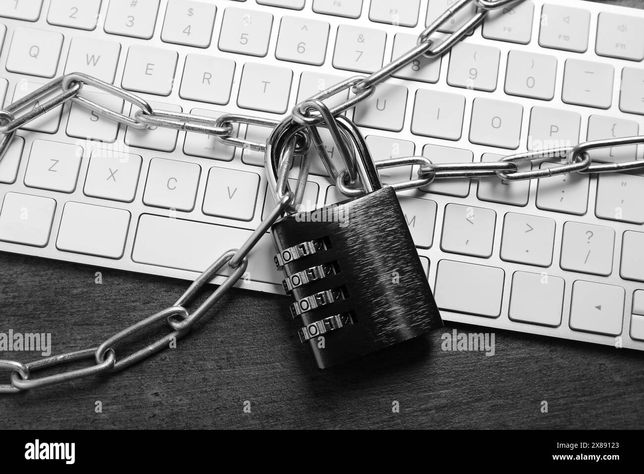 Cyber security. Metal combination padlock with chain and keyboard on ...