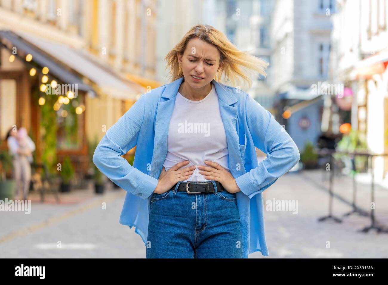 Caucasian young woman traveler feeling sudden strong abdominal stomach ...