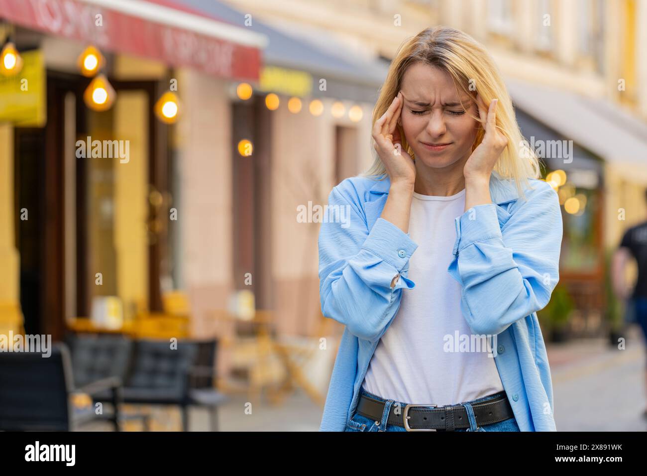 Displeased exhausted Caucasian woman rubbing temples to cure headache ...