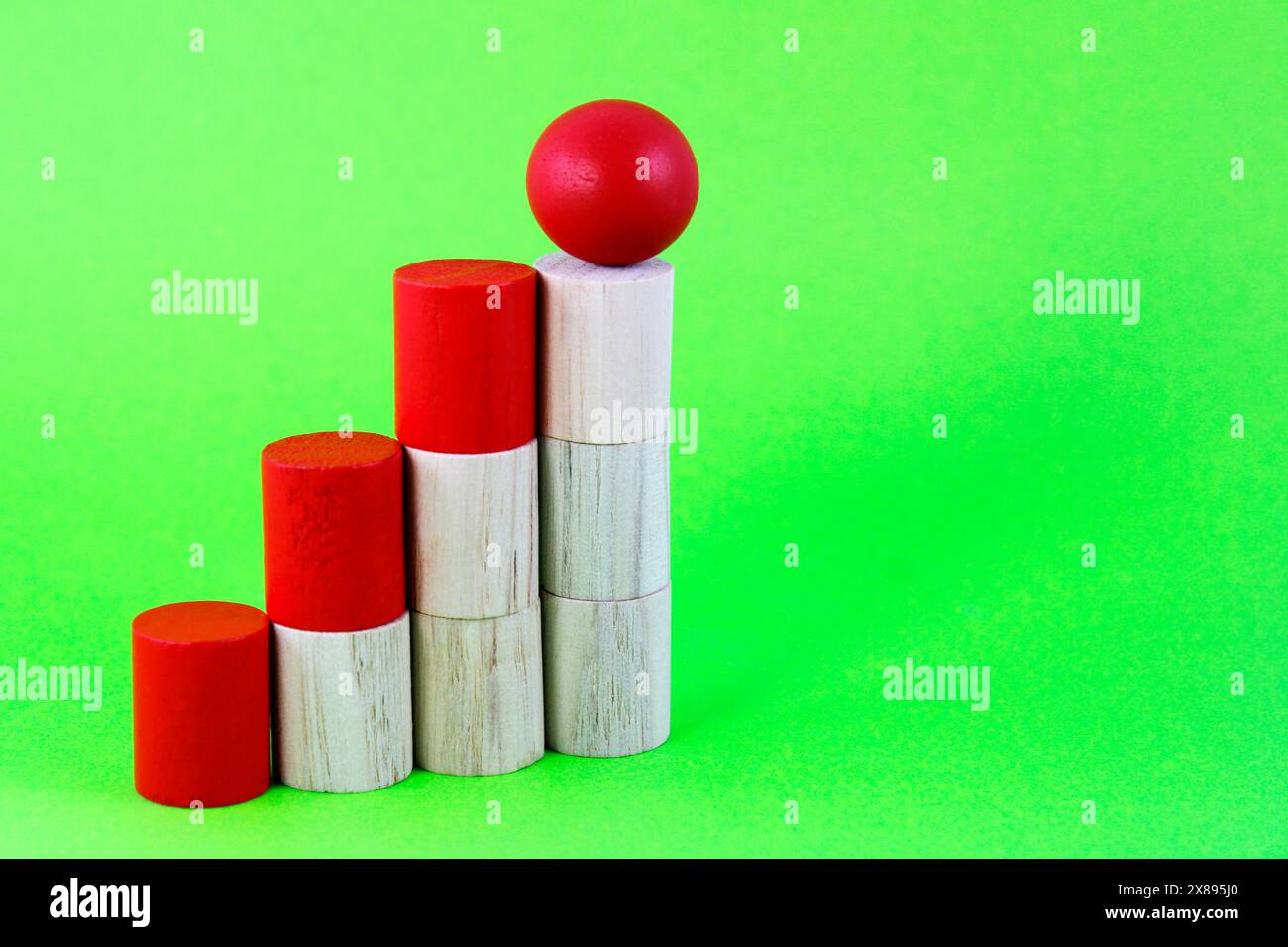 Sphere on levels formed by wooden cylinders Stock Photo - Alamy