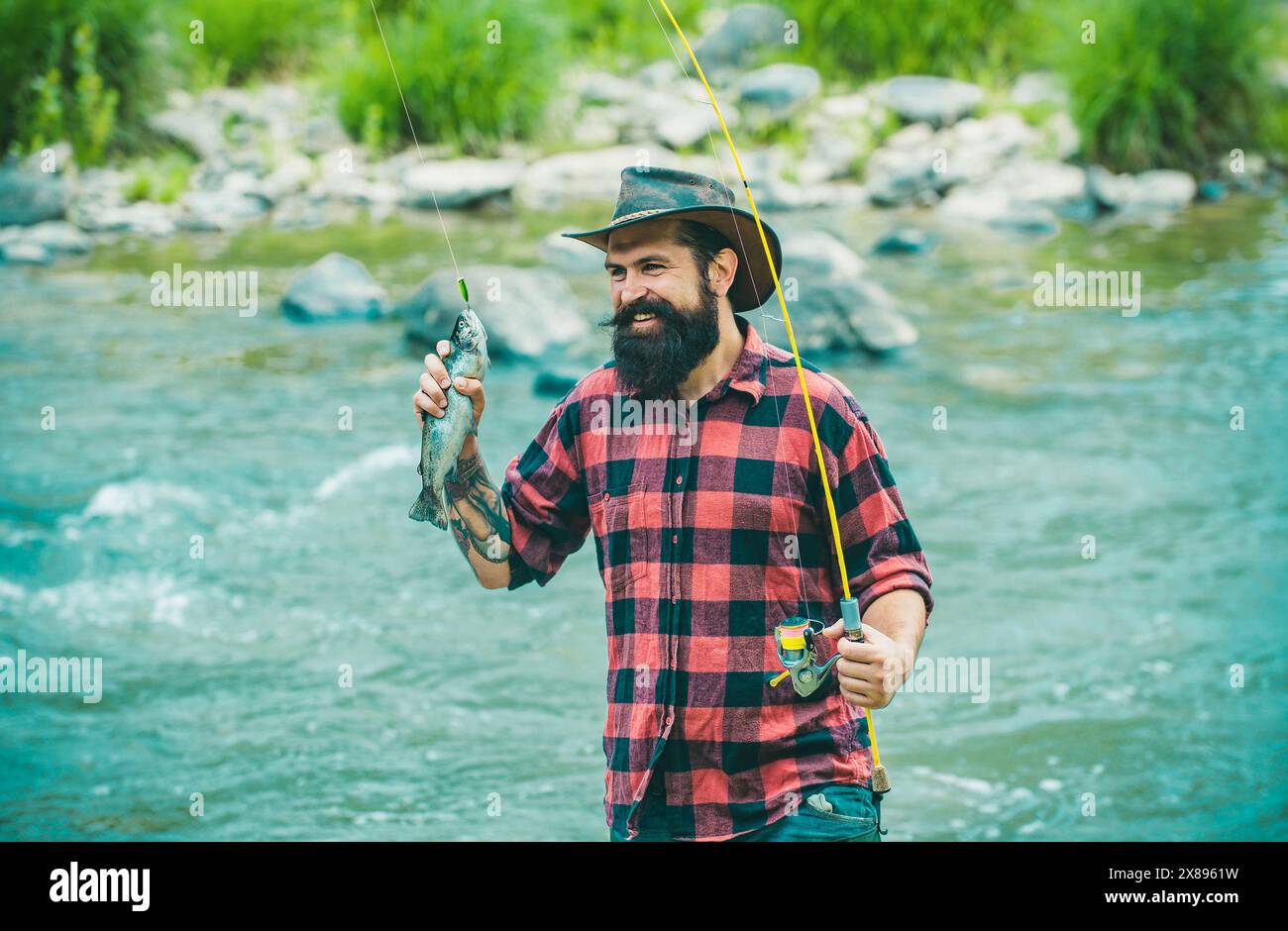 Bass fishing. Fisherman and trophy trout. River grayling on the hook ...