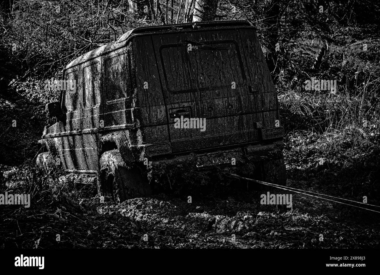 Jeep crashed into a puddle and picked up a spray of dirt. Track on mud ...